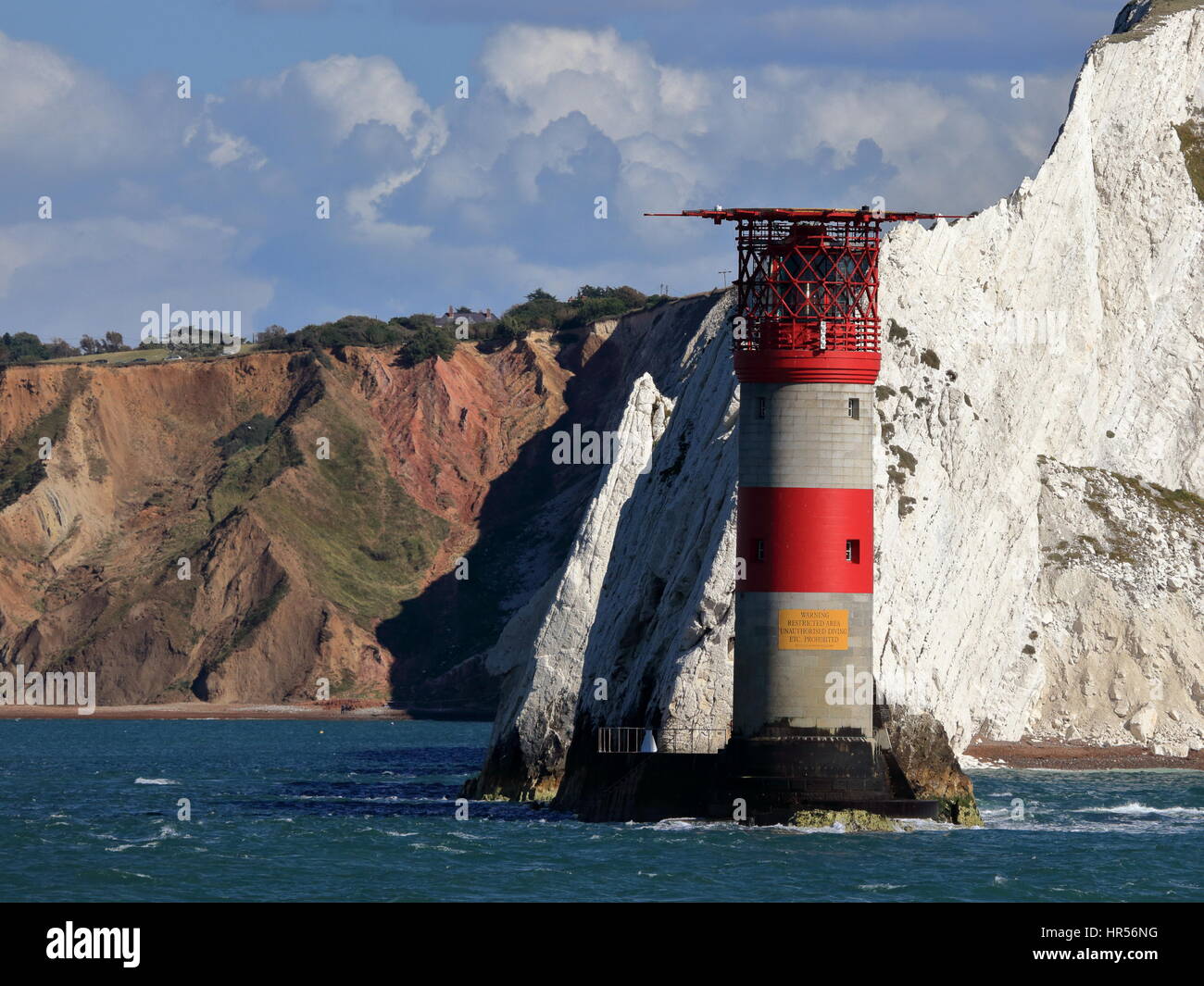 Imposing red and white Trinity Lighthouse tipping the familiar Needles ...