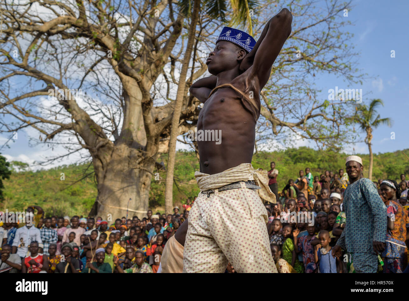 A Fulani boy hits his opponent with a whip made out of a branch. The ...
