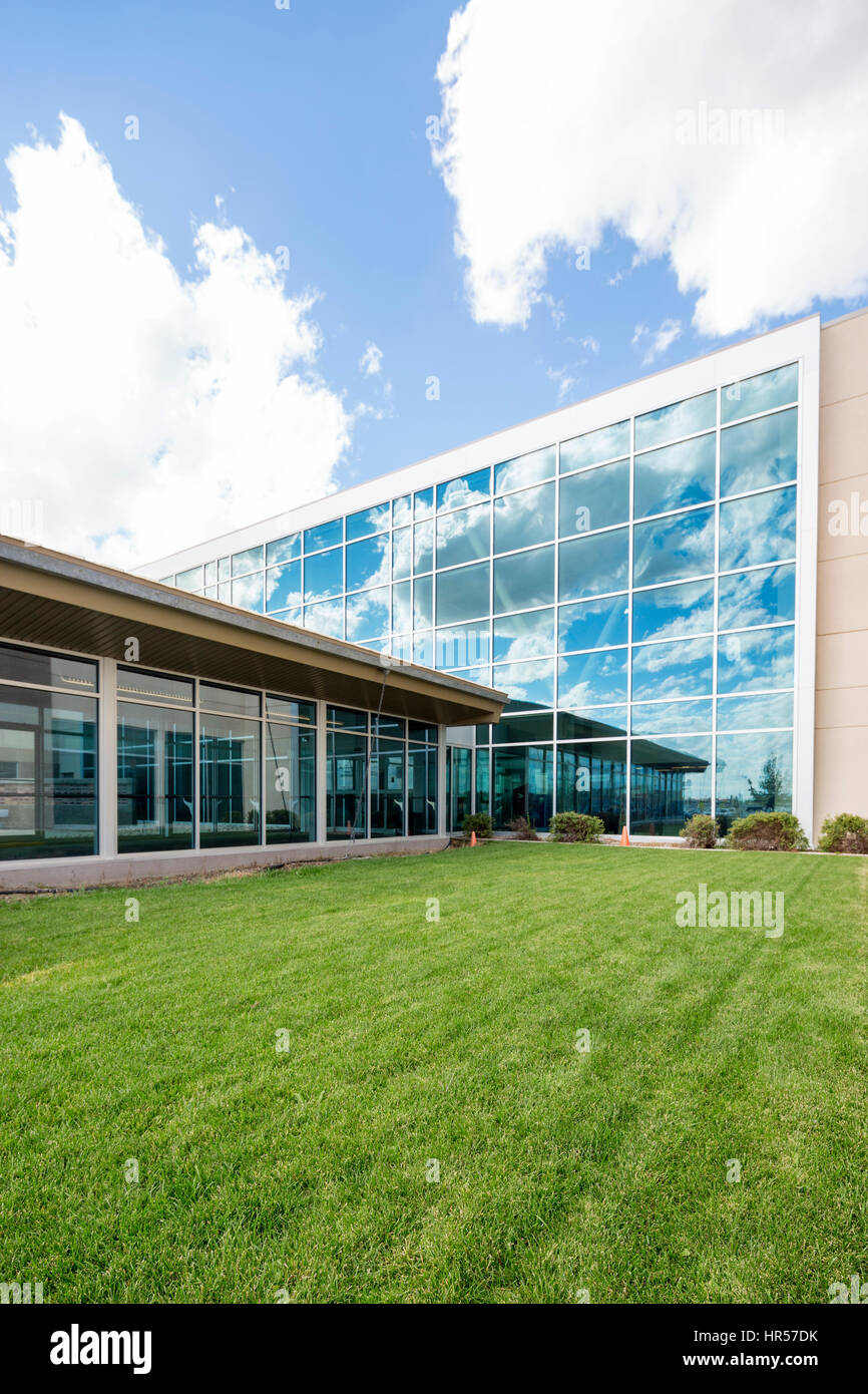 Exterior of modern hospital building with glass windows against sky ...