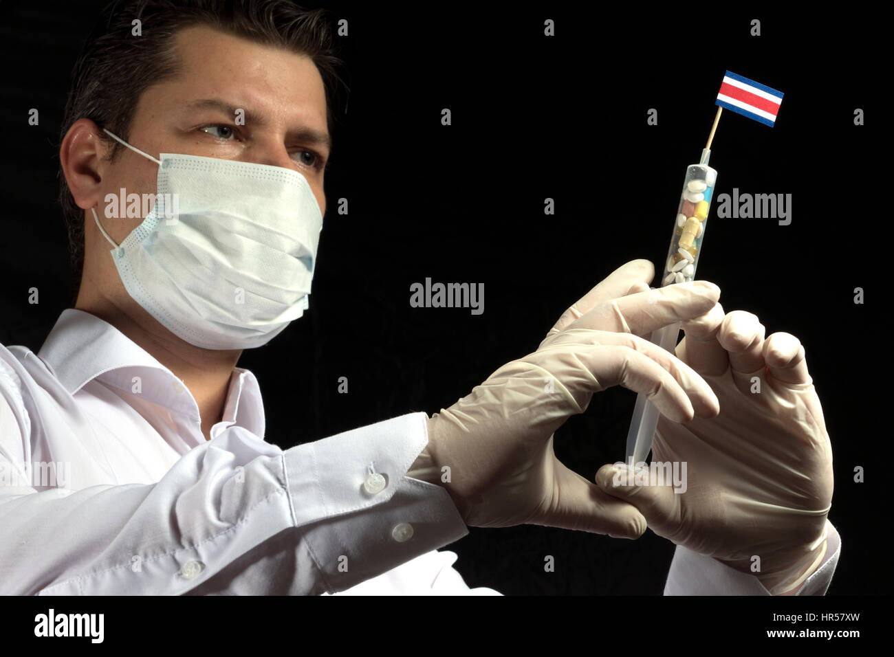 Young man as a doctor gives a medical injection to Costa Rican flag on ...