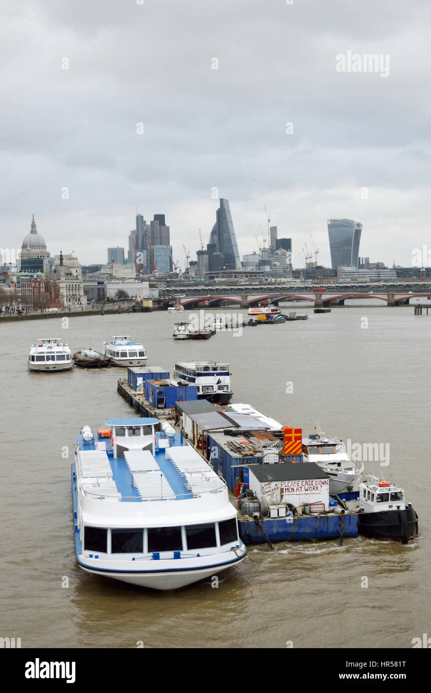 River cruise boat on the Thames river with financial district skyline ...