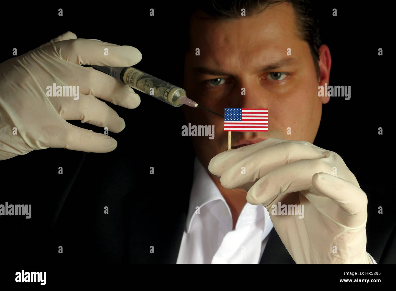 Young businessman gives a financial injection to United States flag ...