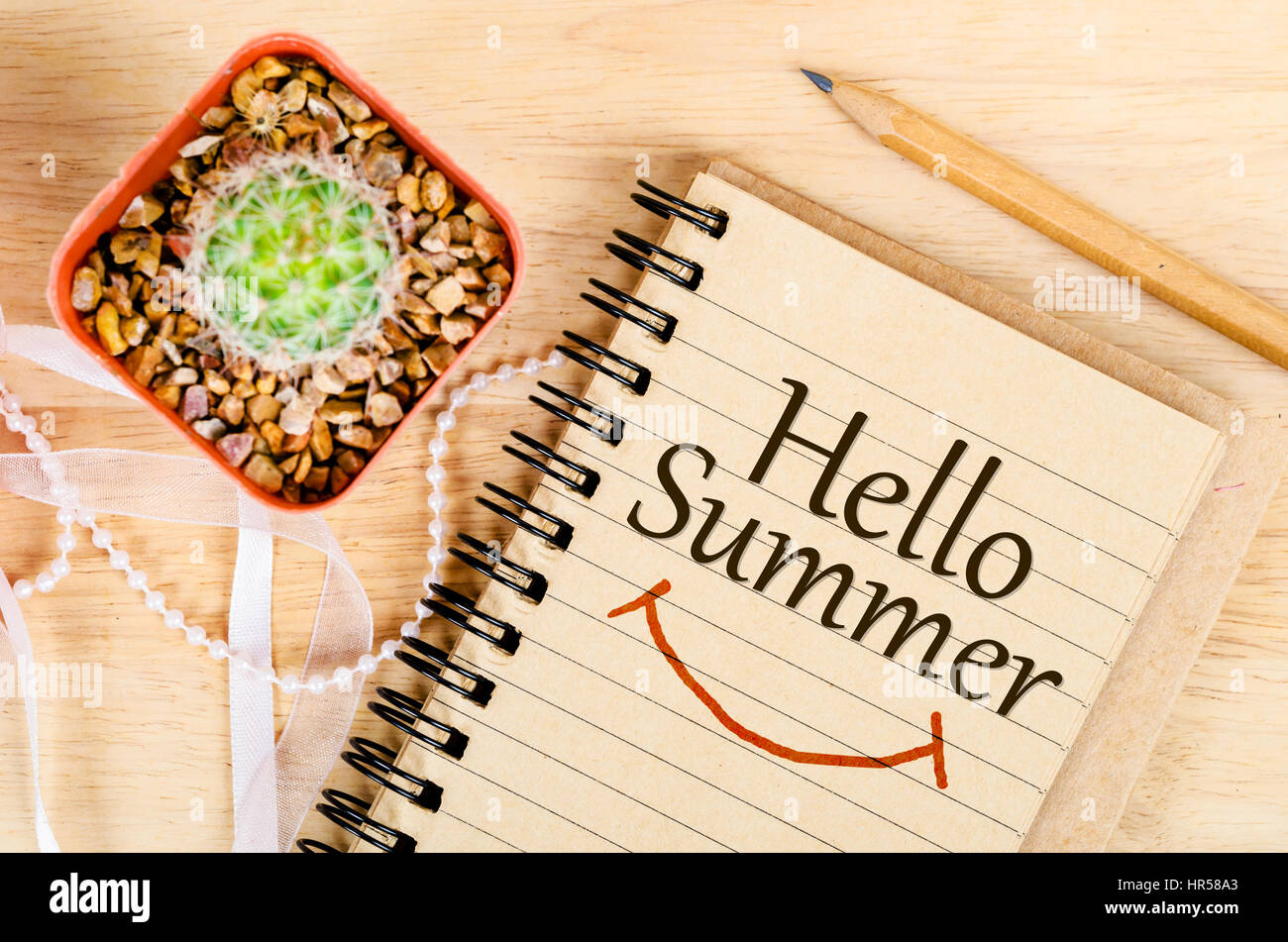 Hello summer on brown notebook with cactus and pencul on wooden ...