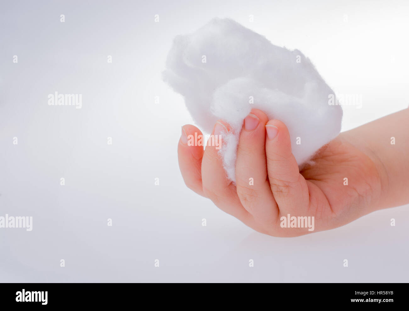 Hand holding some cotton in hand on a white background Stock Photo - Alamy