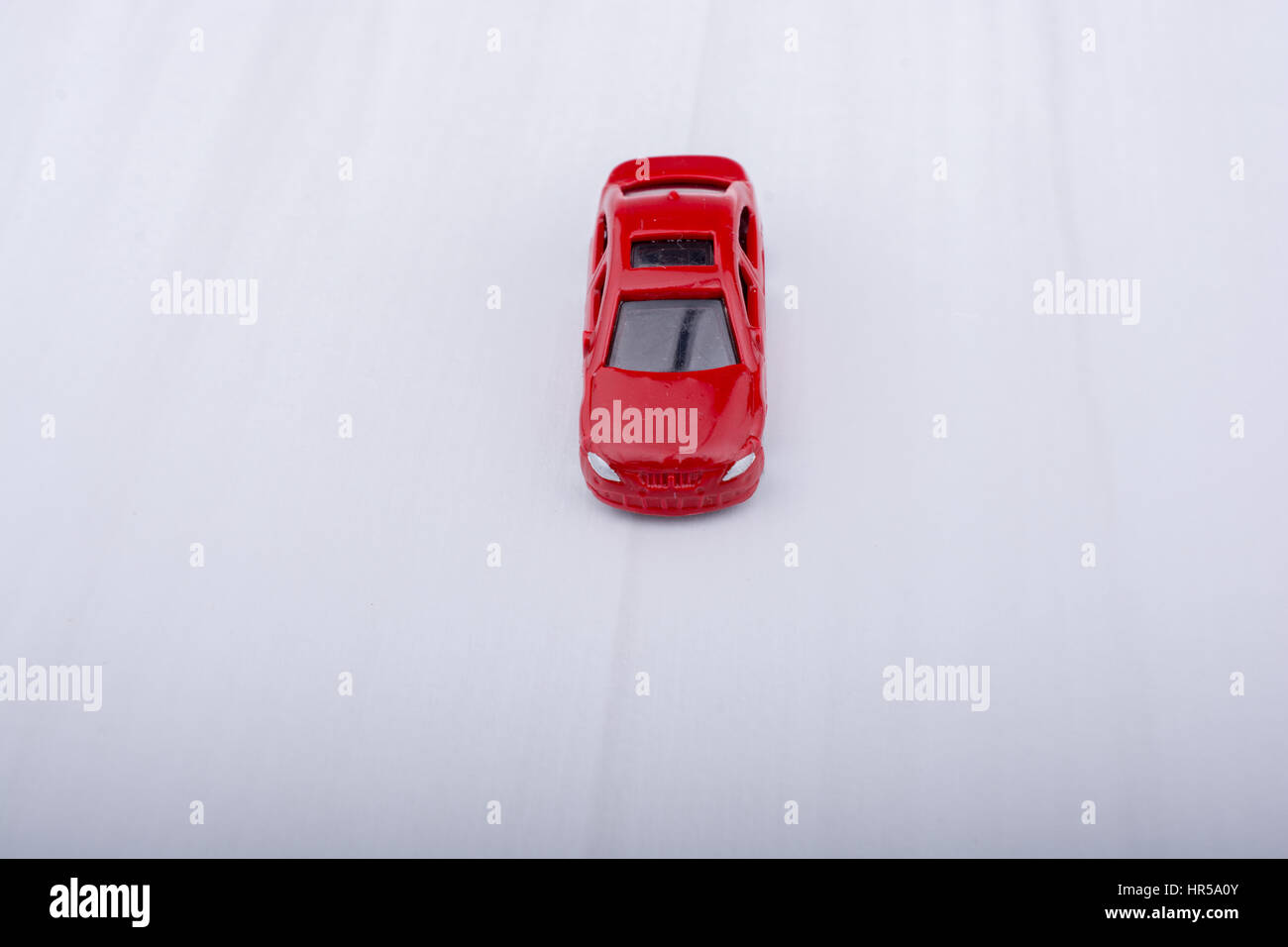 Colorful little toy car on a grey background Stock Photo - Alamy
