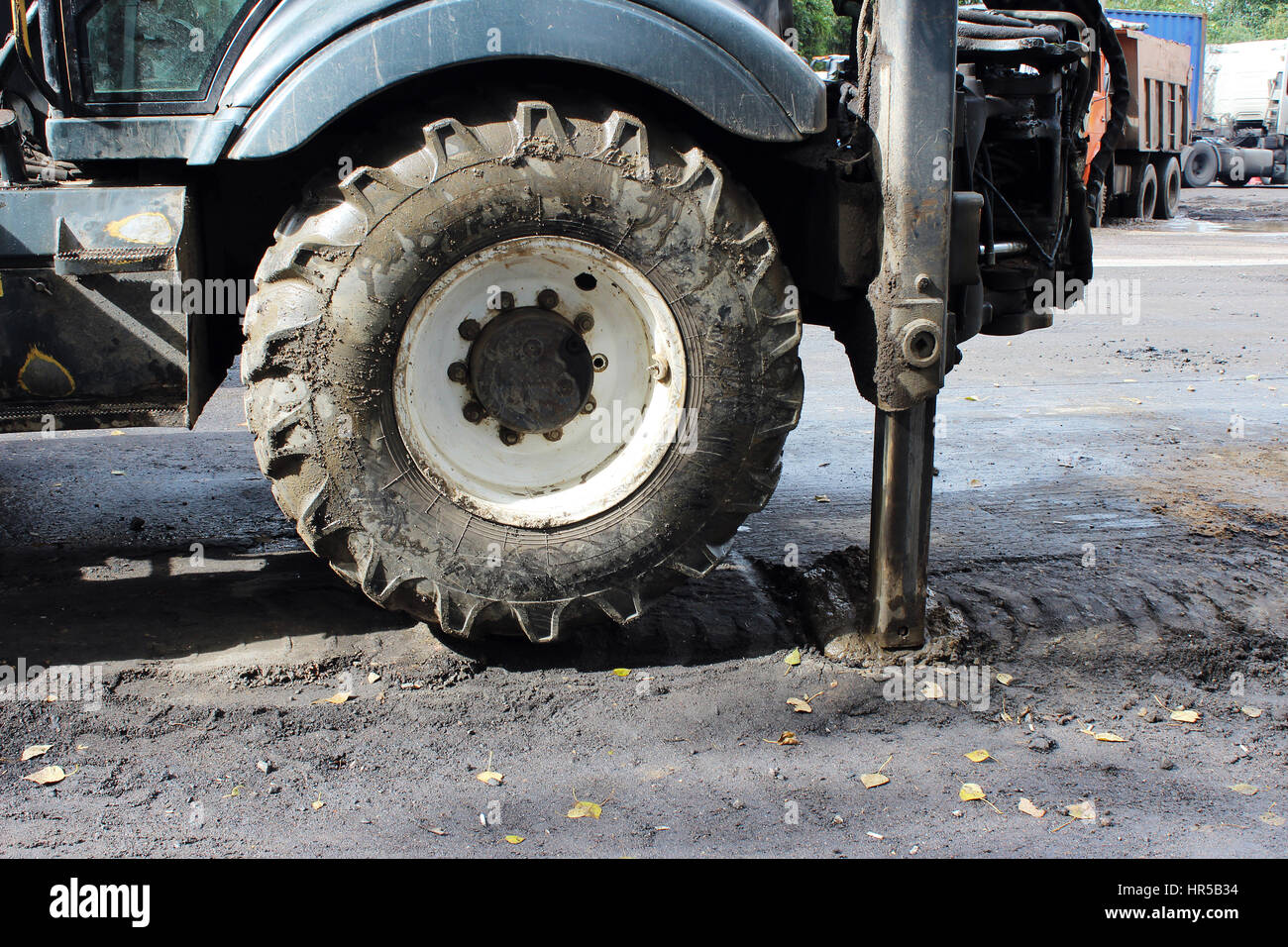 Tractor strong outrigger stabilizing legs extended to stabilize and ...