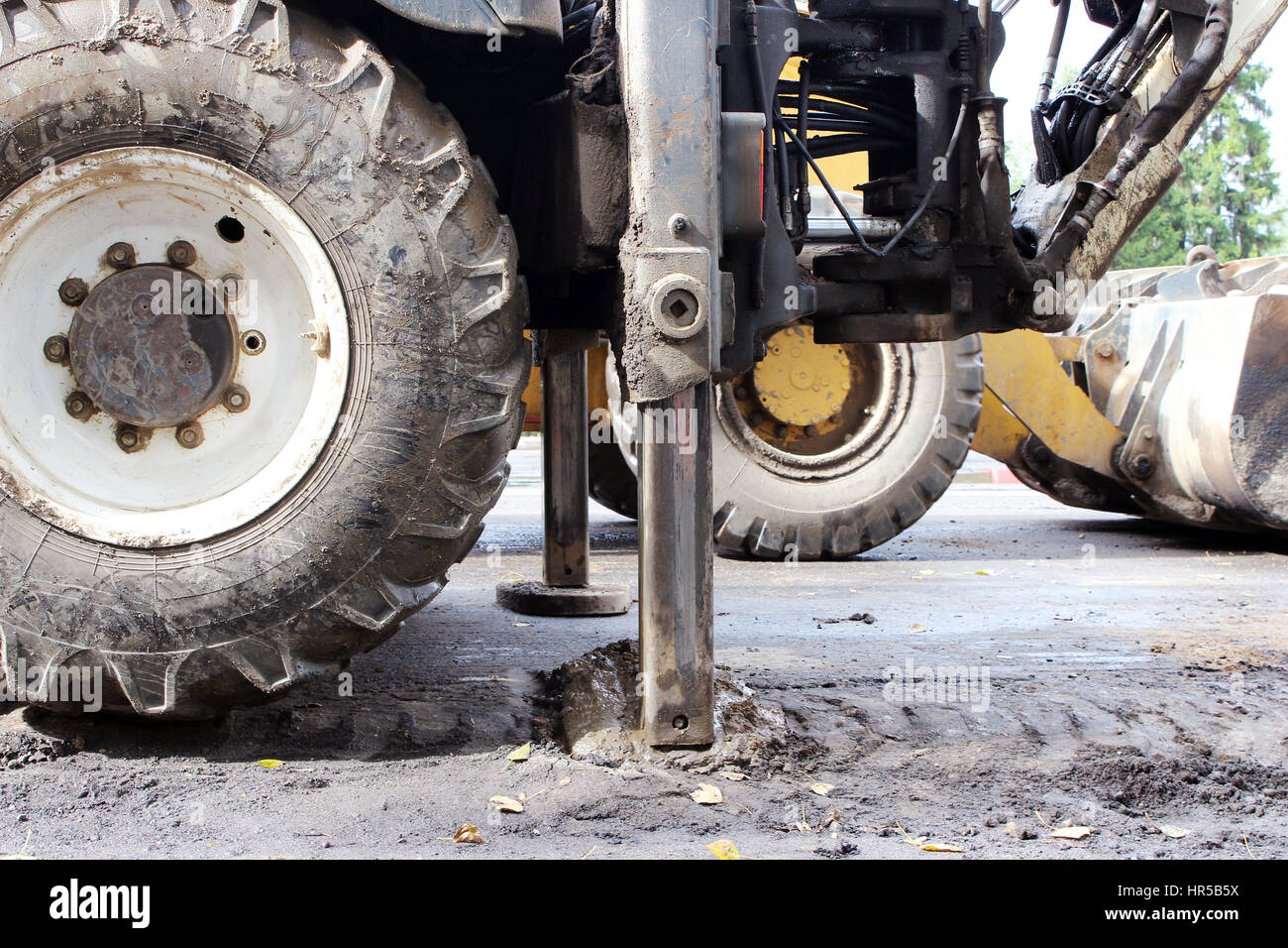 Tractor strong outrigger stabilizing legs extended to stabilize and ...