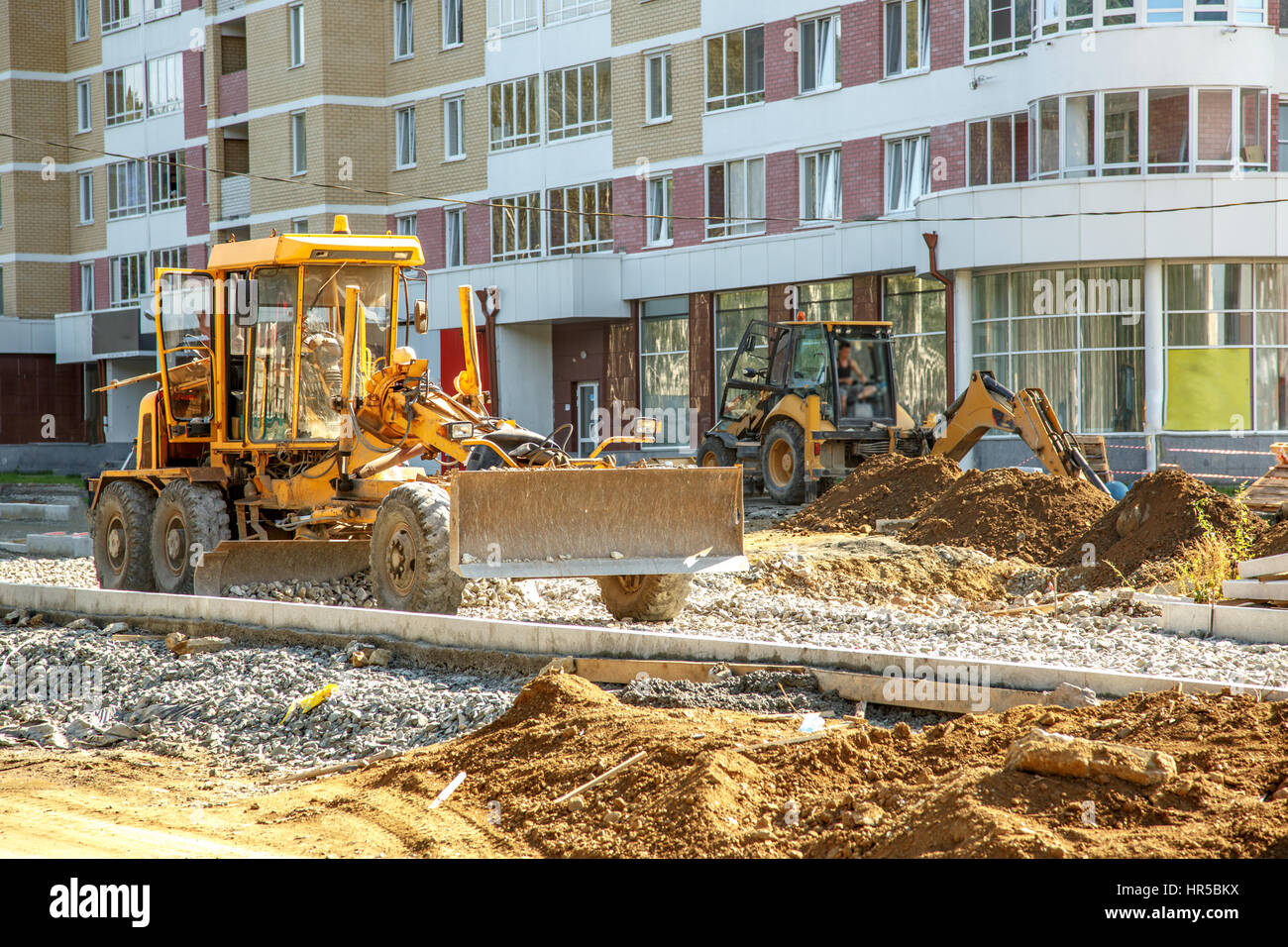 Grader working outside on road construction in summer Stock Photo - Alamy