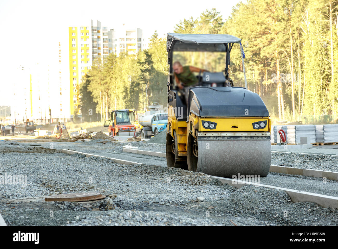 Road roller working at road construction site Stock Photo - Alamy