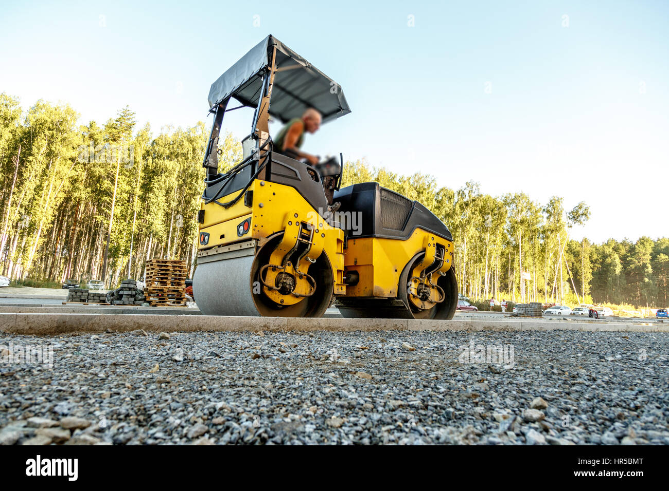 Road roller working at road construction site Stock Photo - Alamy