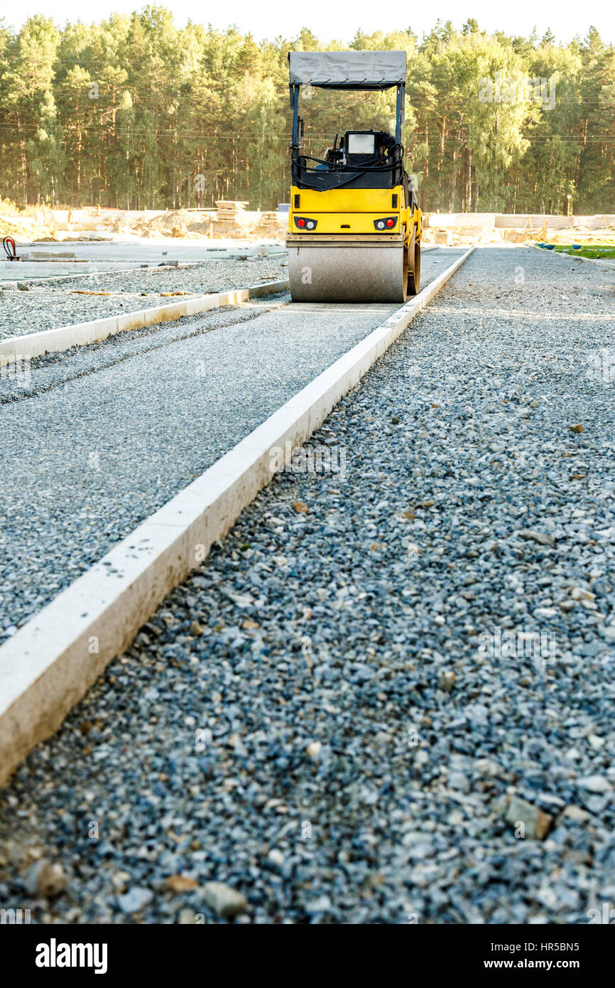 Road roller working at road construction site Stock Photo - Alamy
