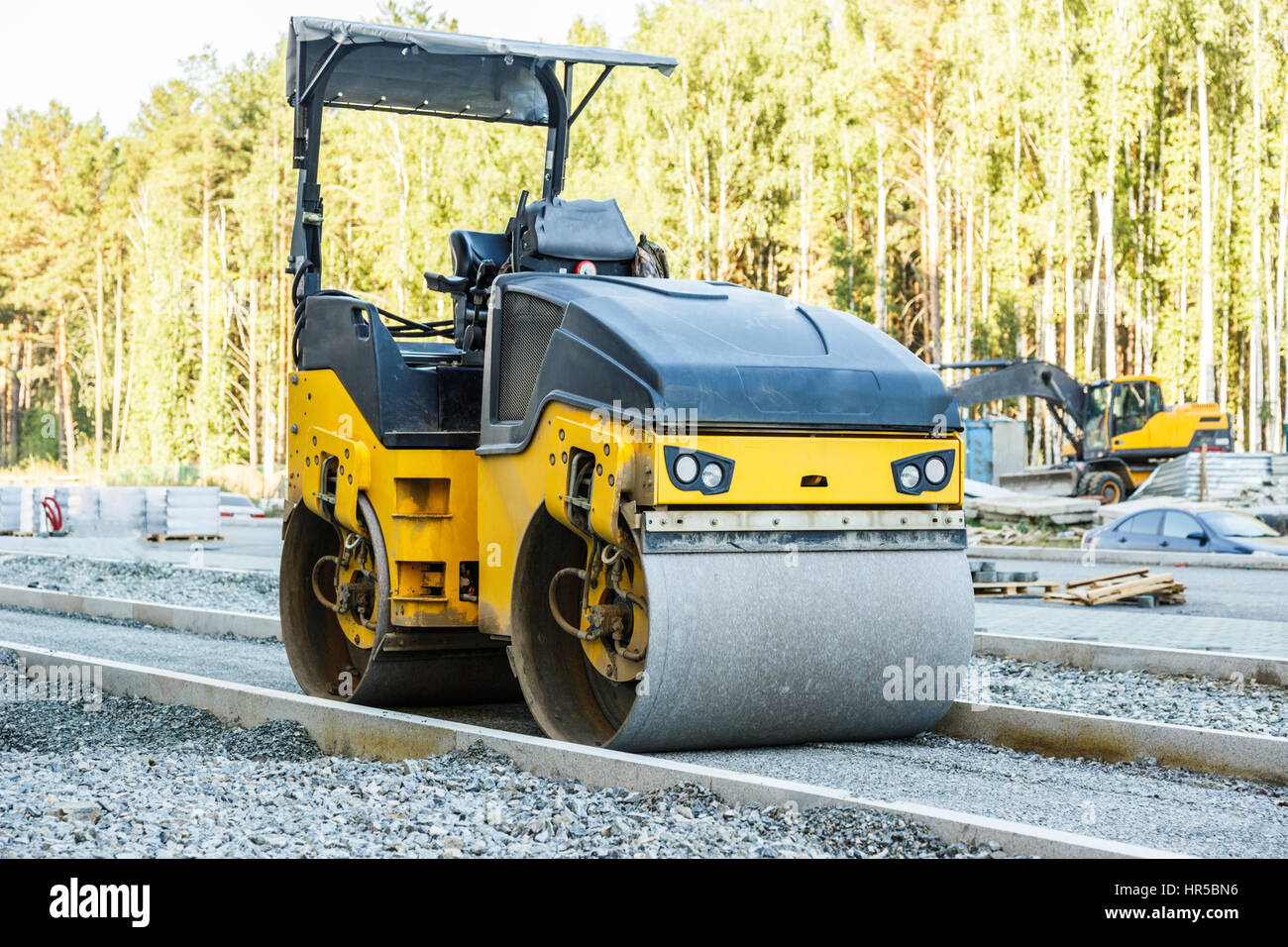 Road roller working at road construction site Stock Photo - Alamy