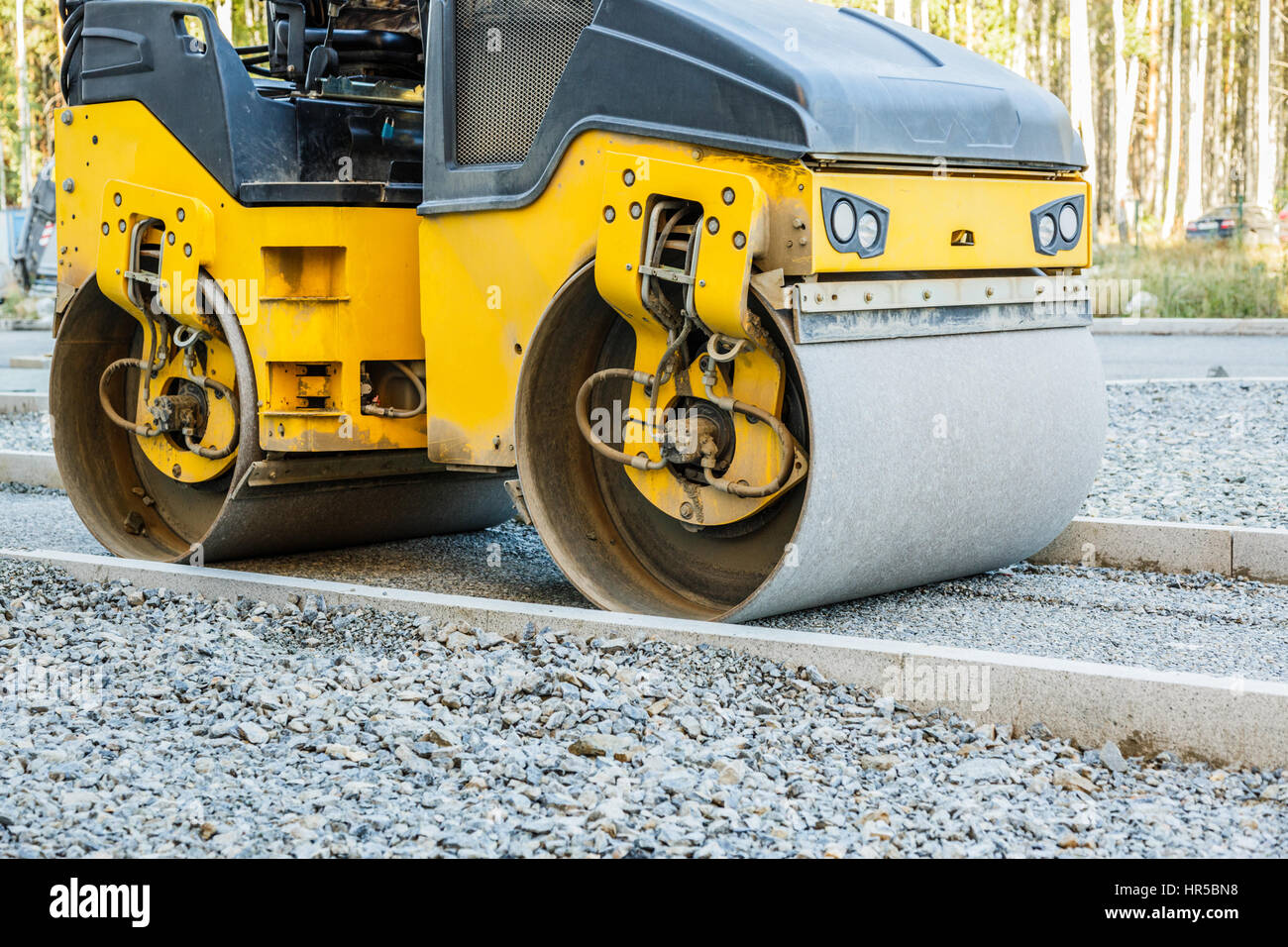 Road roller working at road construction site Stock Photo - Alamy