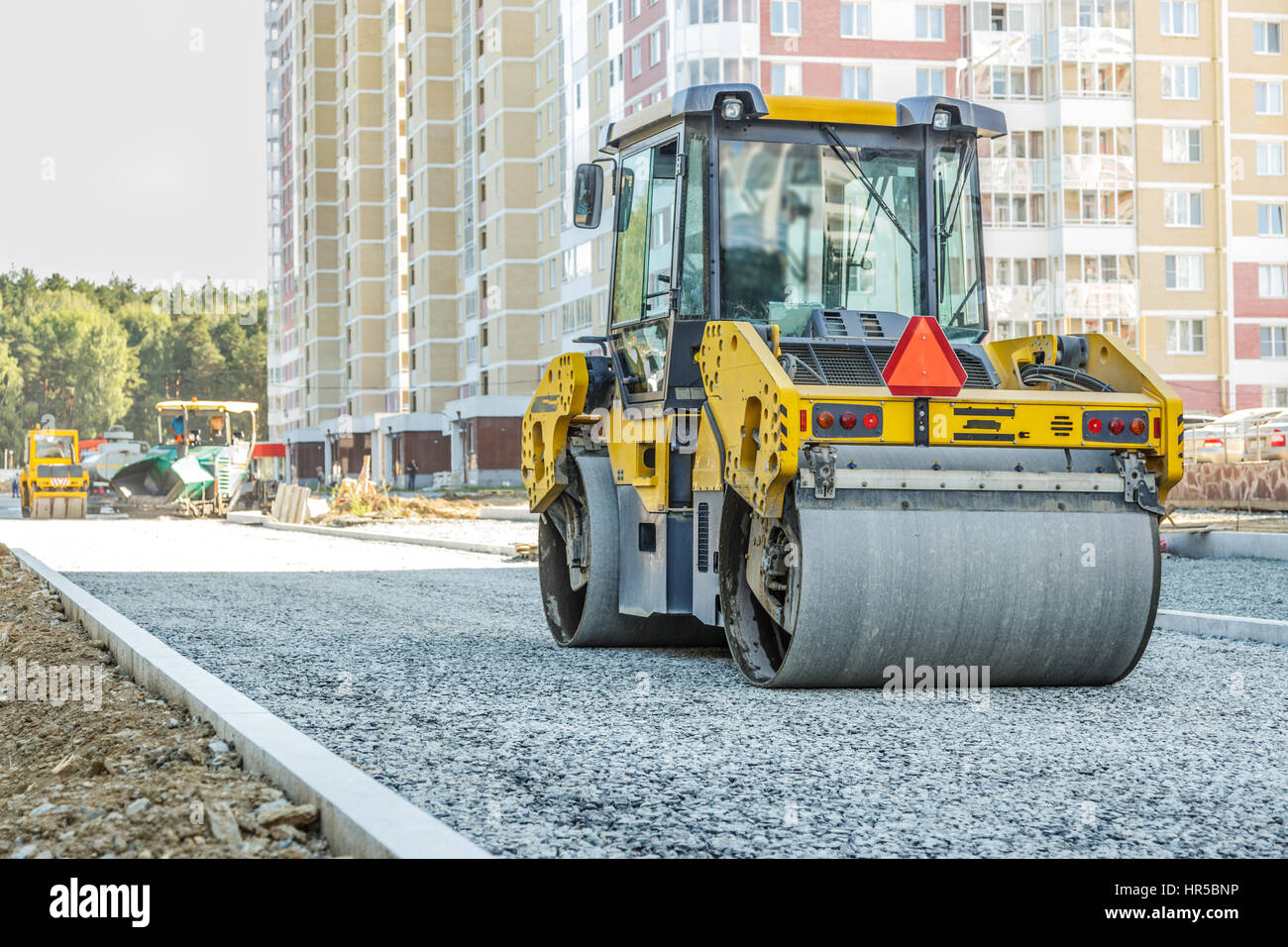 Road roller working at road construction site Stock Photo - Alamy