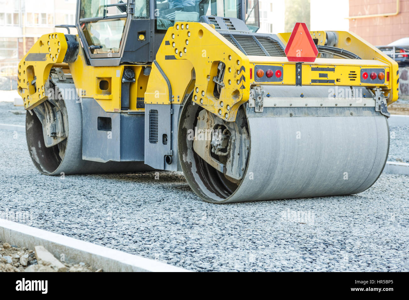 Road roller working at road construction site Stock Photo - Alamy