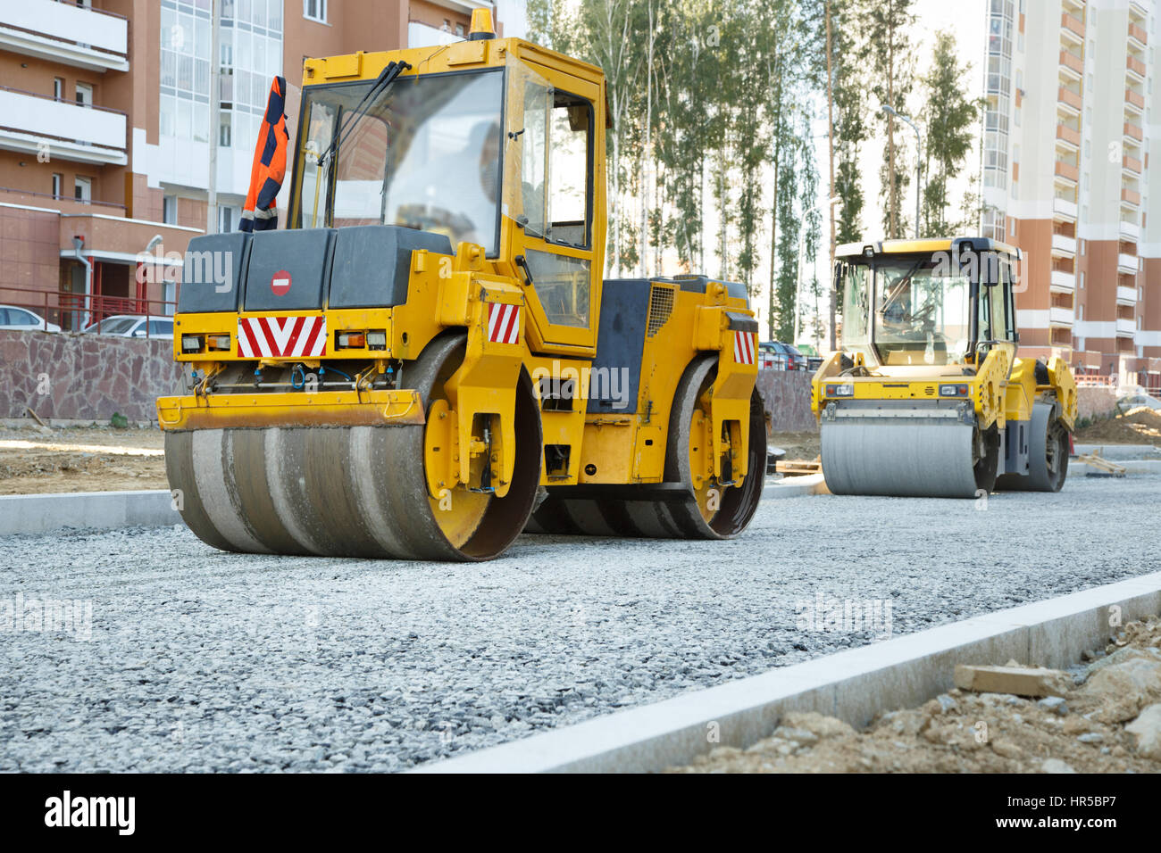 Road roller working at road construction site Stock Photo - Alamy