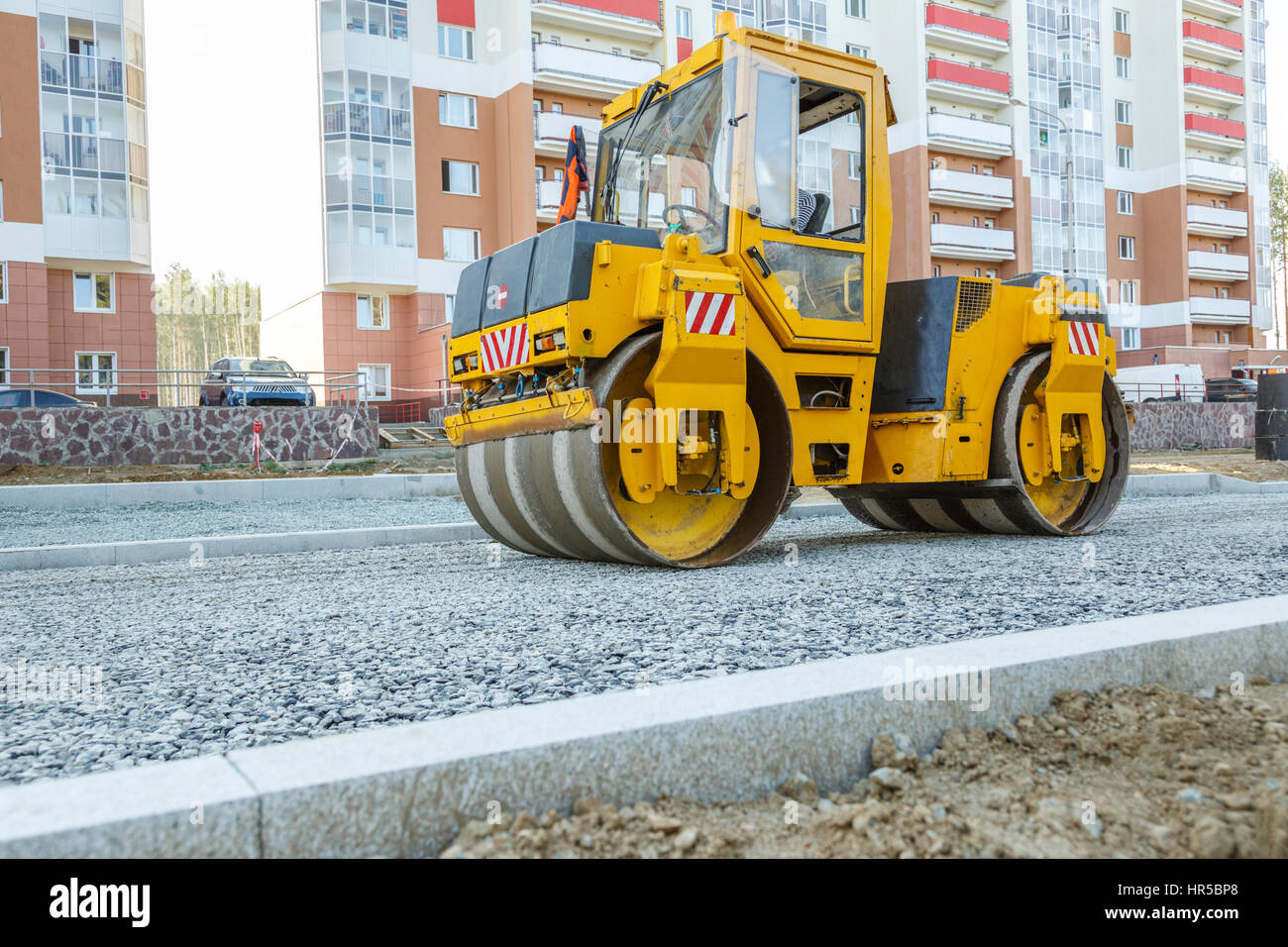 Road roller working at road construction site Stock Photo - Alamy