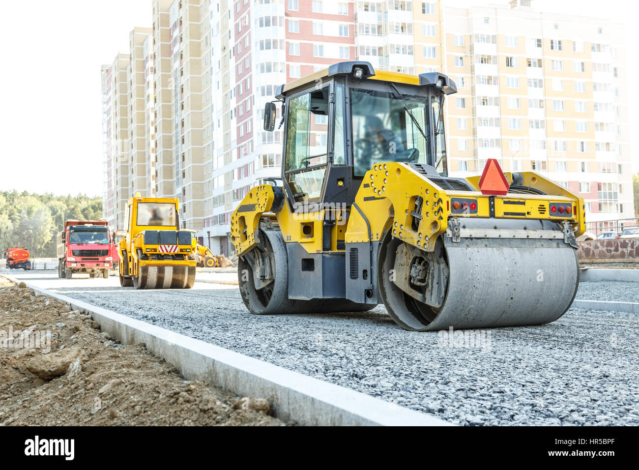 Road roller working at road construction site Stock Photo - Alamy