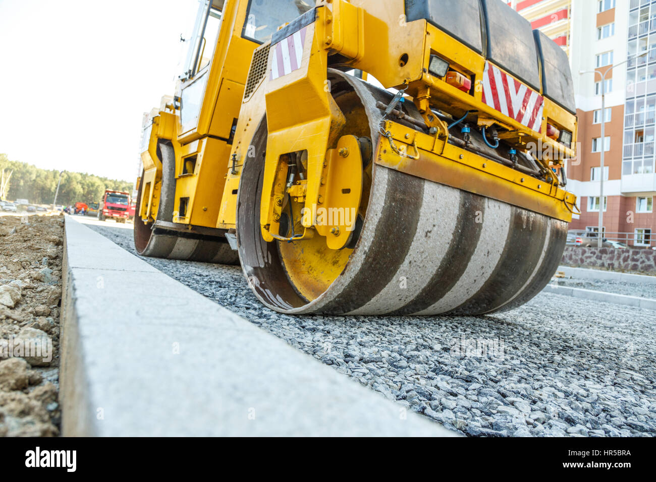 Road roller working at road construction site Stock Photo - Alamy
