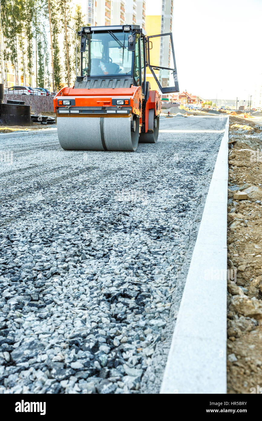 Road roller working at road construction site Stock Photo - Alamy