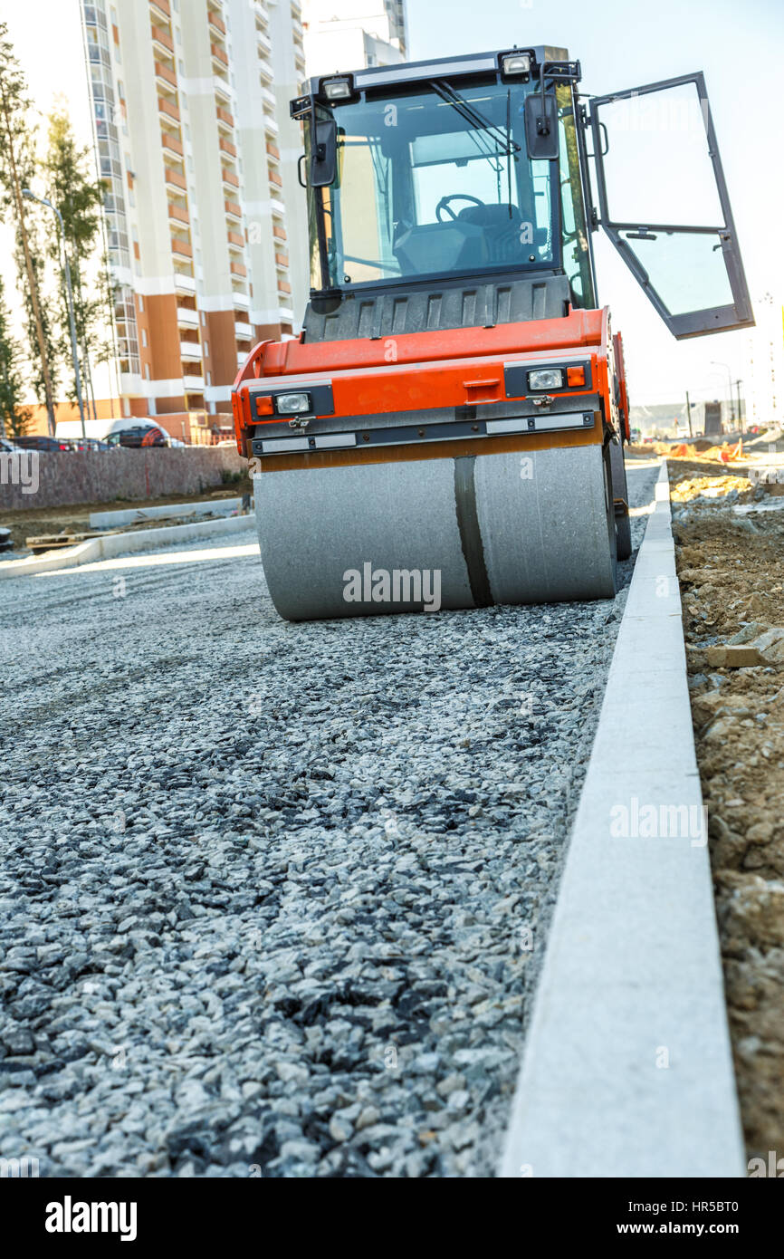 Road roller working at road construction site Stock Photo - Alamy