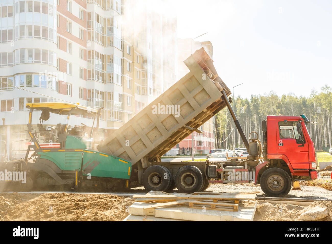 Asphalt-placing machine working on the city road Stock Photo - Alamy