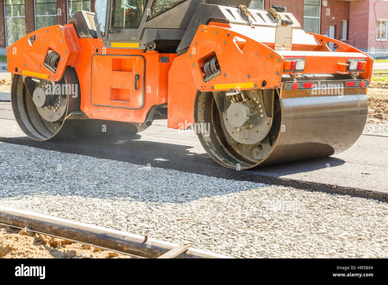 Road roller working at road construction site Stock Photo - Alamy
