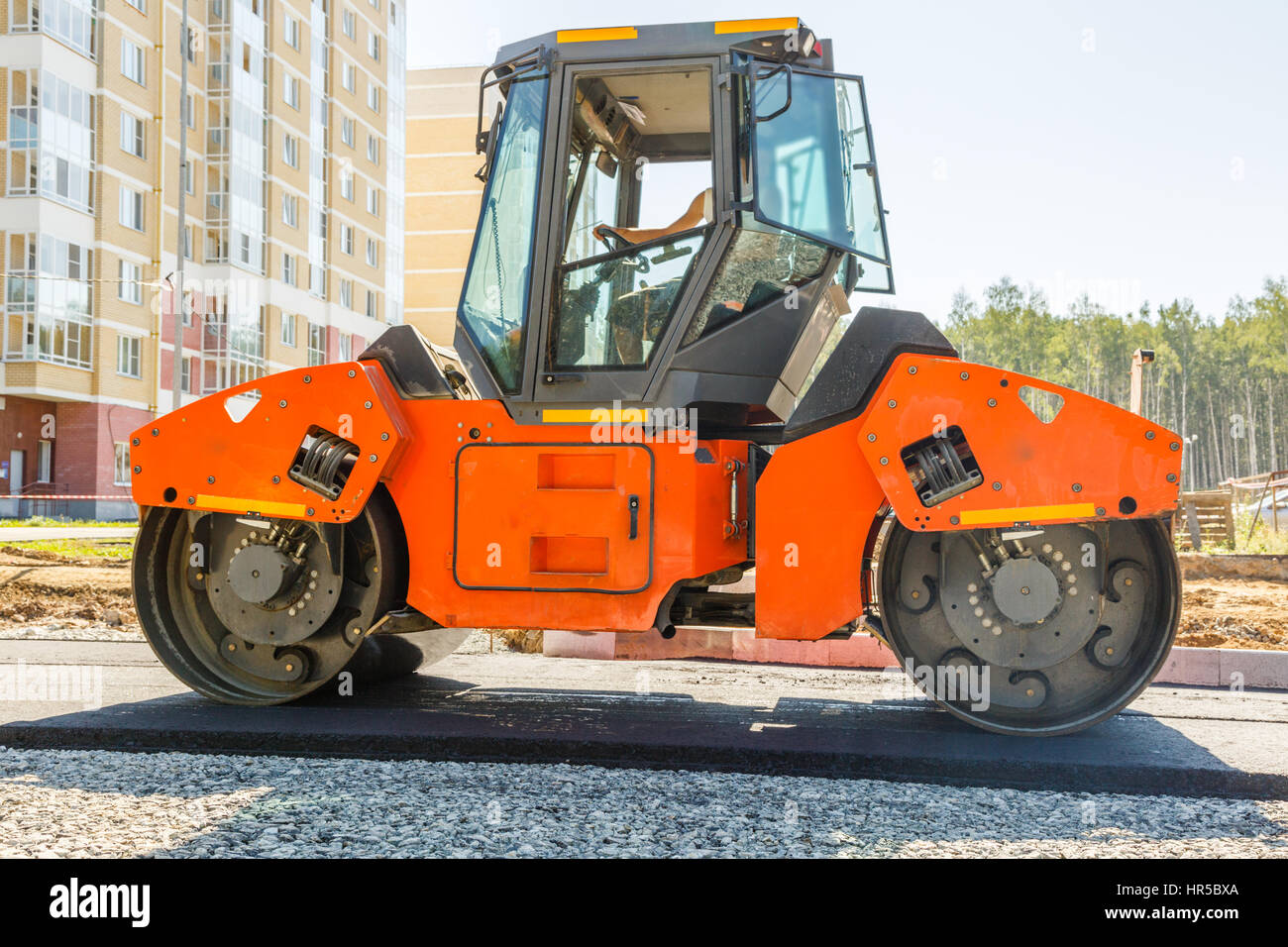 Road roller working at road construction site Stock Photo - Alamy