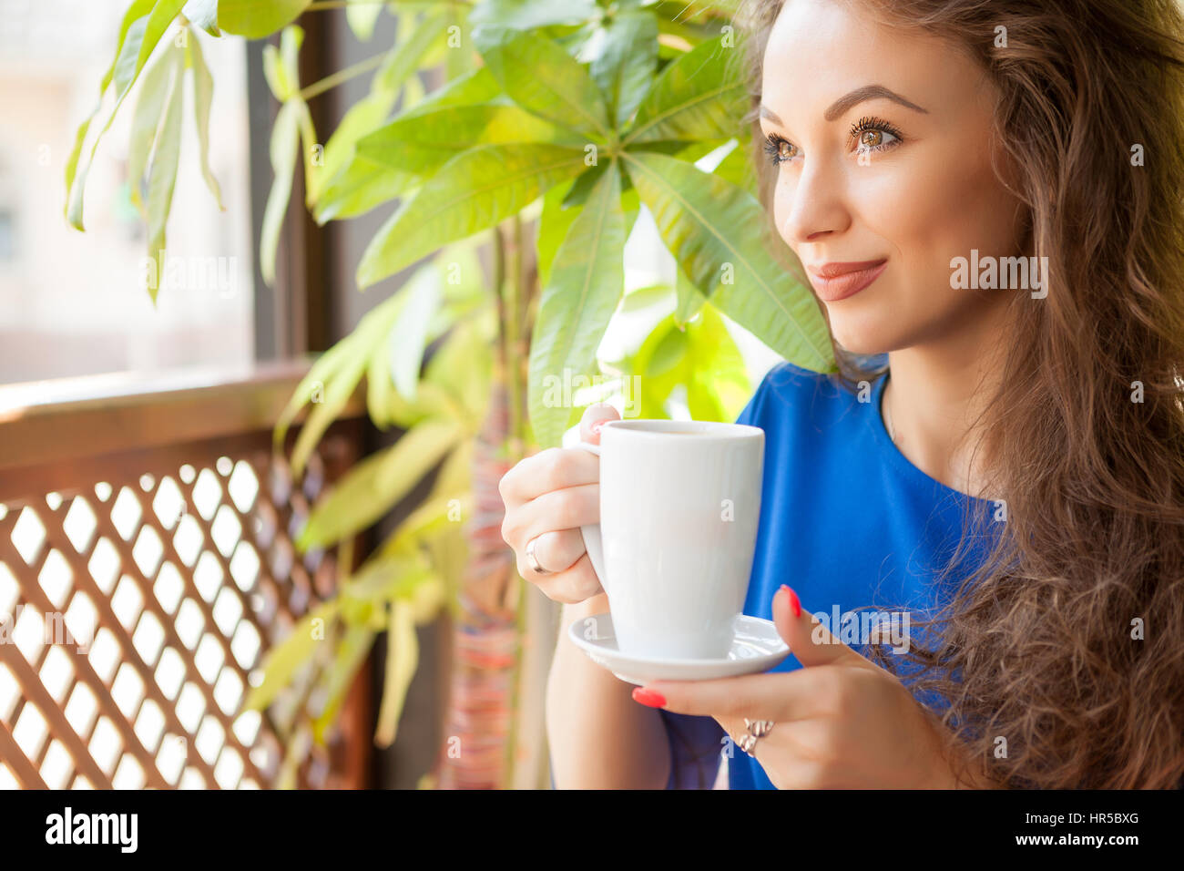 Attractive woman drinking coffe in a coffee shop. Beautiful young woman ...