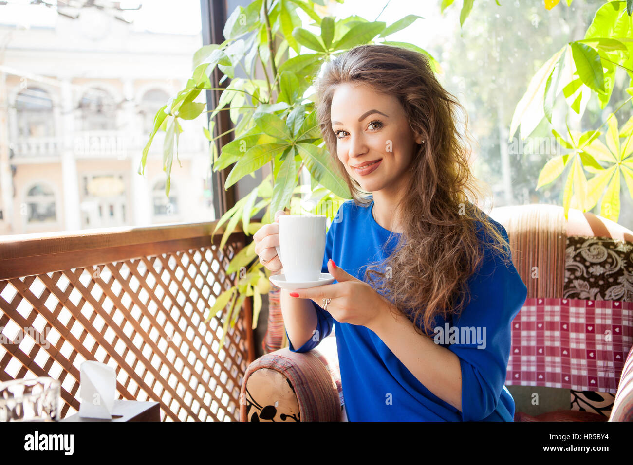 Happy beautiful woman drinking coffe in a coffee shop. Beautiful young ...