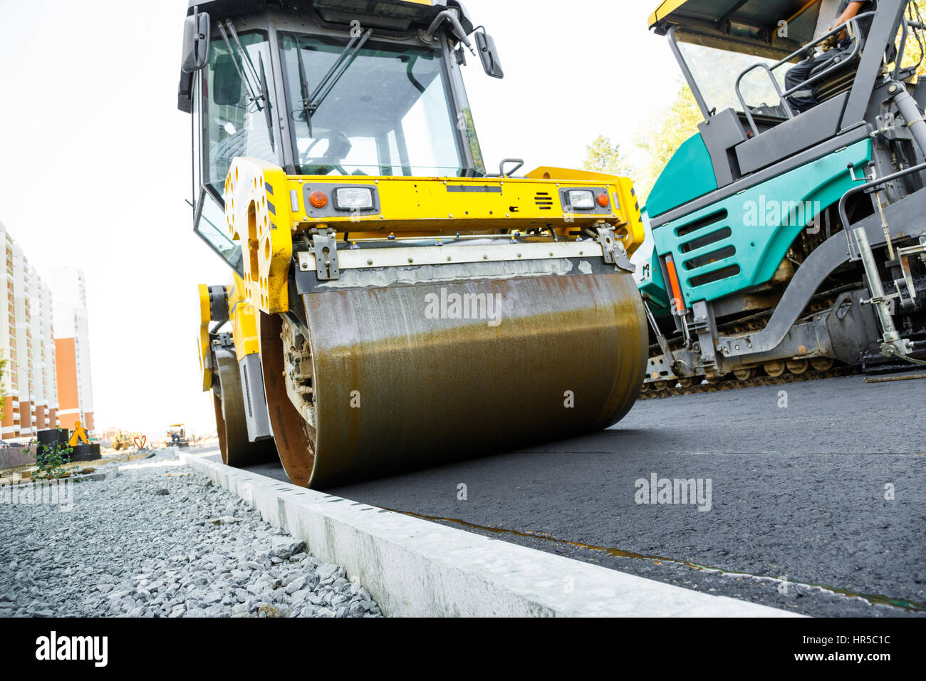 Road roller working at road construction site Stock Photo - Alamy