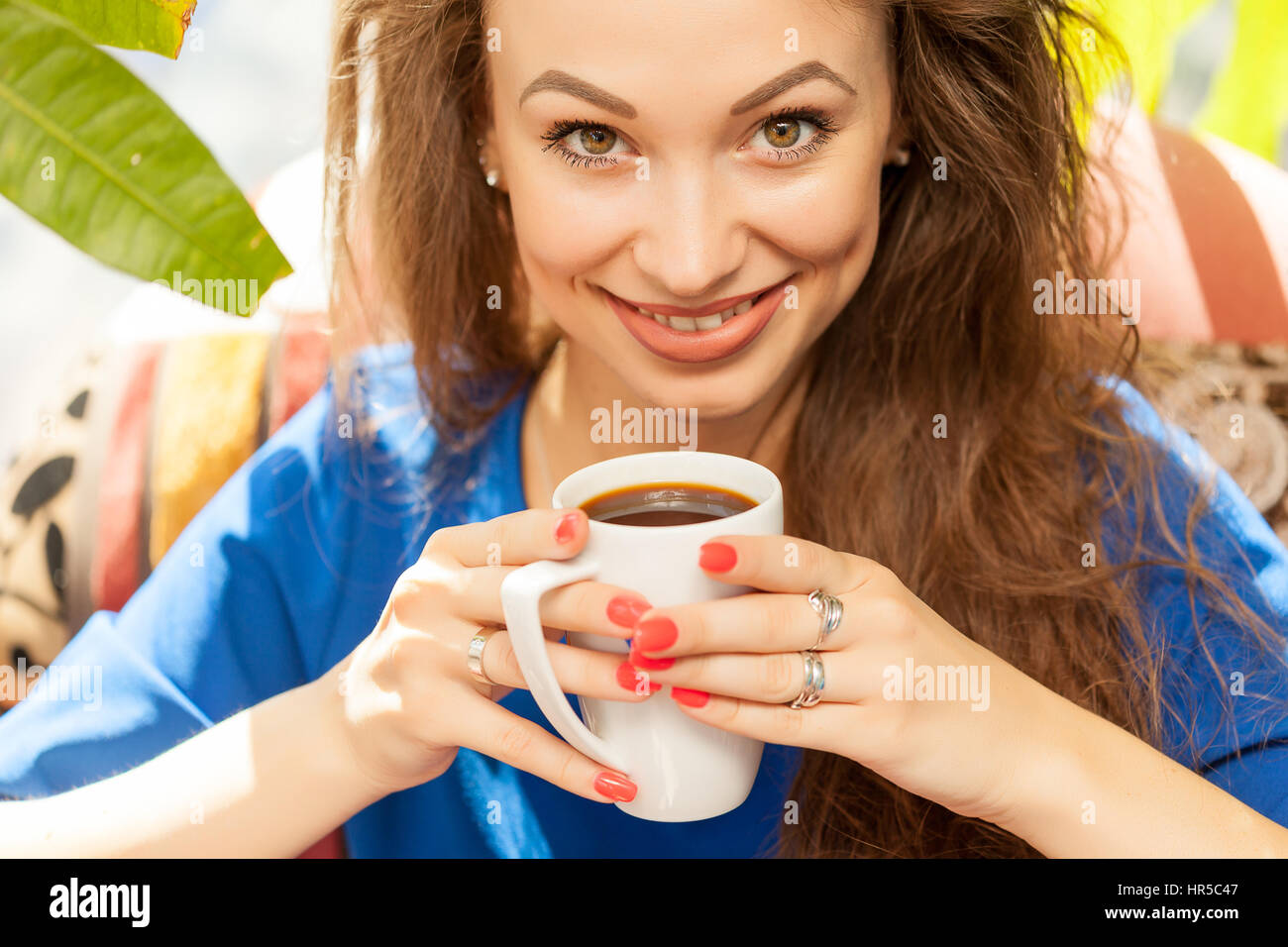 Attractive young woman drinking coffe in a coffee shop. Beautiful young ...