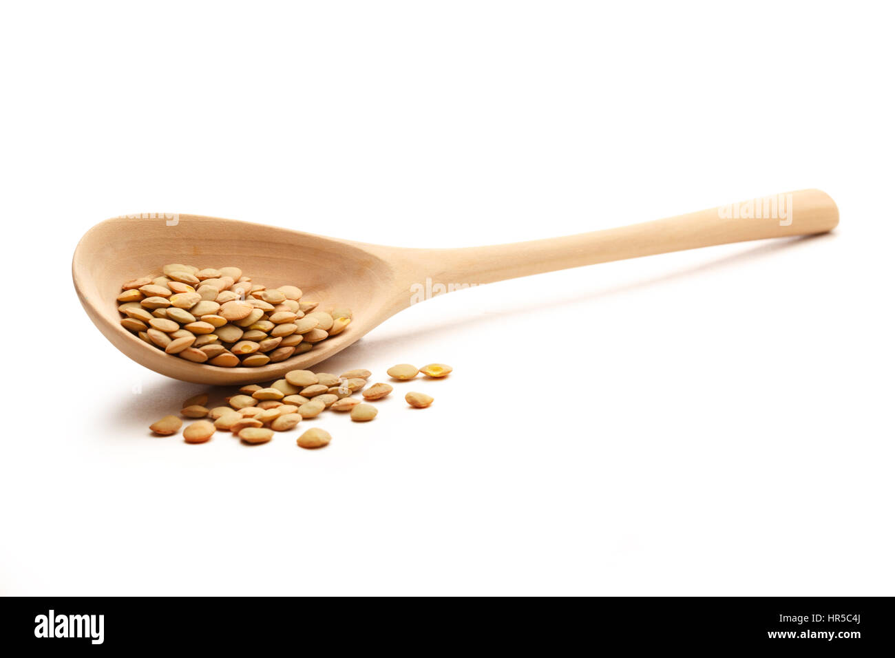 Raw lentil in wooden spoon on white background Stock Photo - Alamy