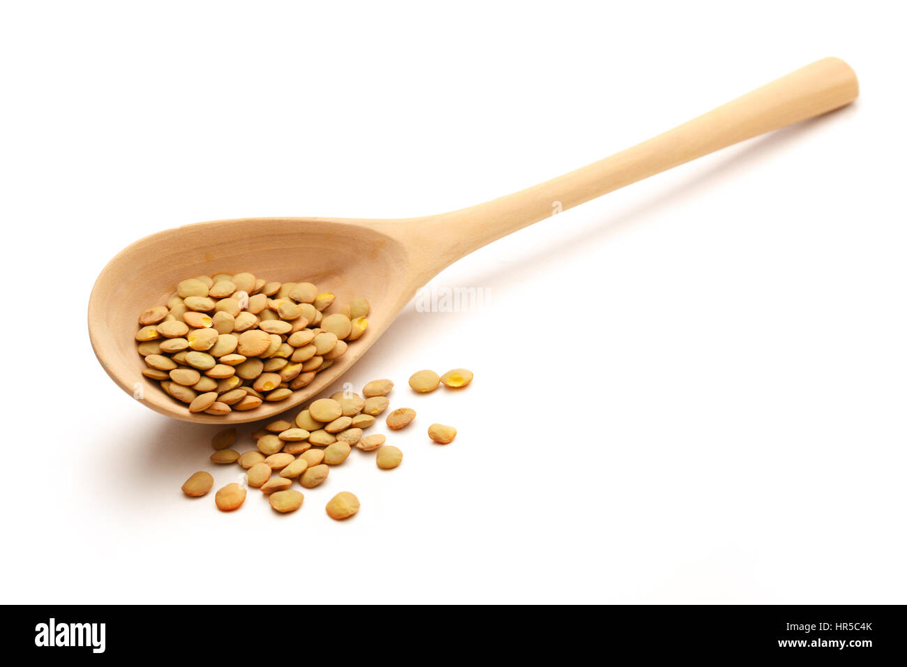 Raw lentil in wooden spoon on white background Stock Photo - Alamy