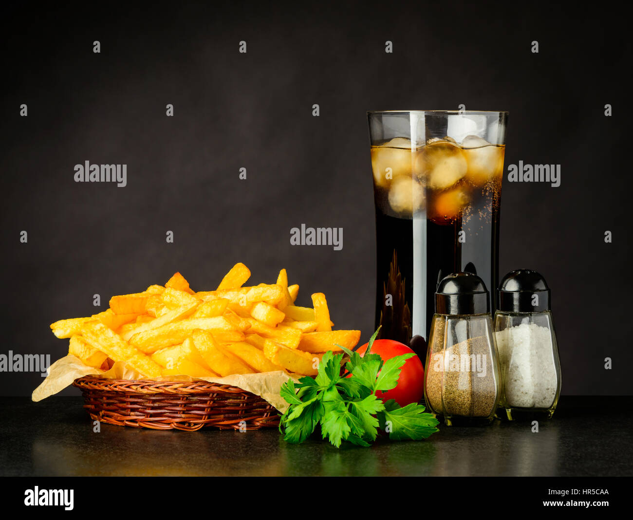 French Fries with Cold Ice Cola and Spices on Dark Background Stock ...