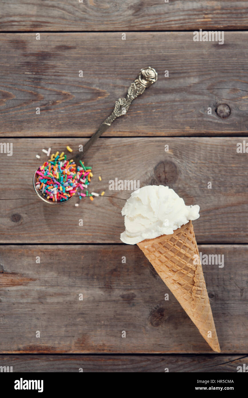 Top view single scoop scoop vanilla ice cream in waffle cone with spoon ...