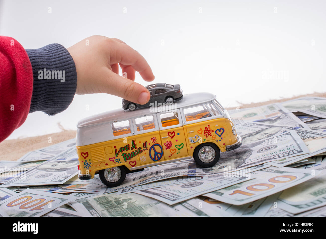 Child hand holding car on Model van on US dollar banknotes Stock Photo ...