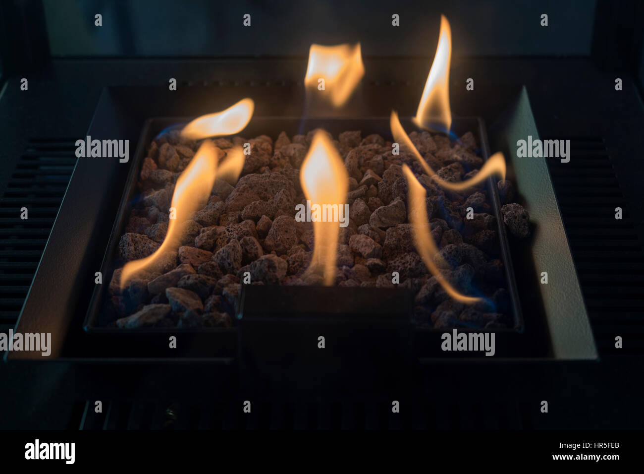 Carbon metal stove with fire heating a room Stock Photo - Alamy