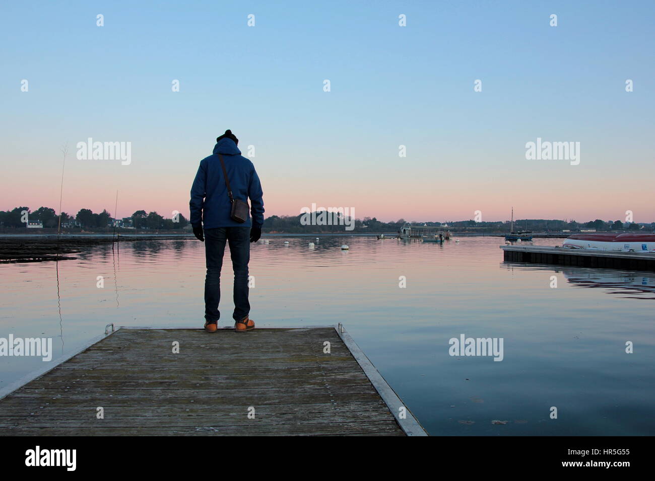 Man on a jetty Stock Photo - Alamy