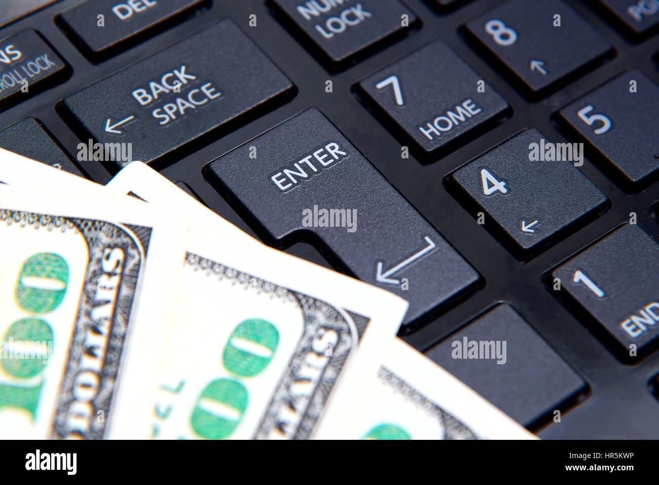 Money on computer keyboard Stock Photo - Alamy