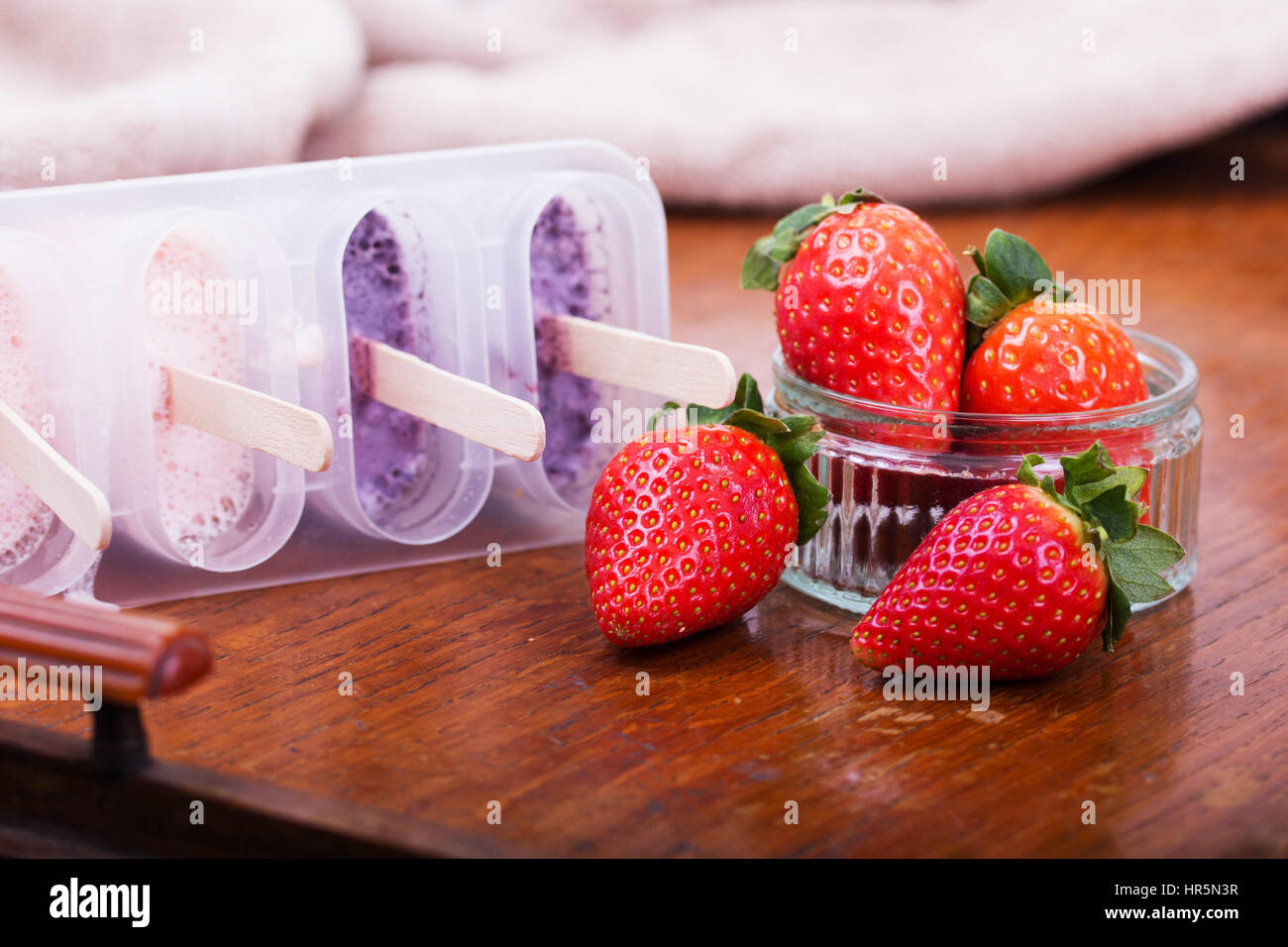 Homemade strawberry ice lolly on a rustic background Stock Photo - Alamy