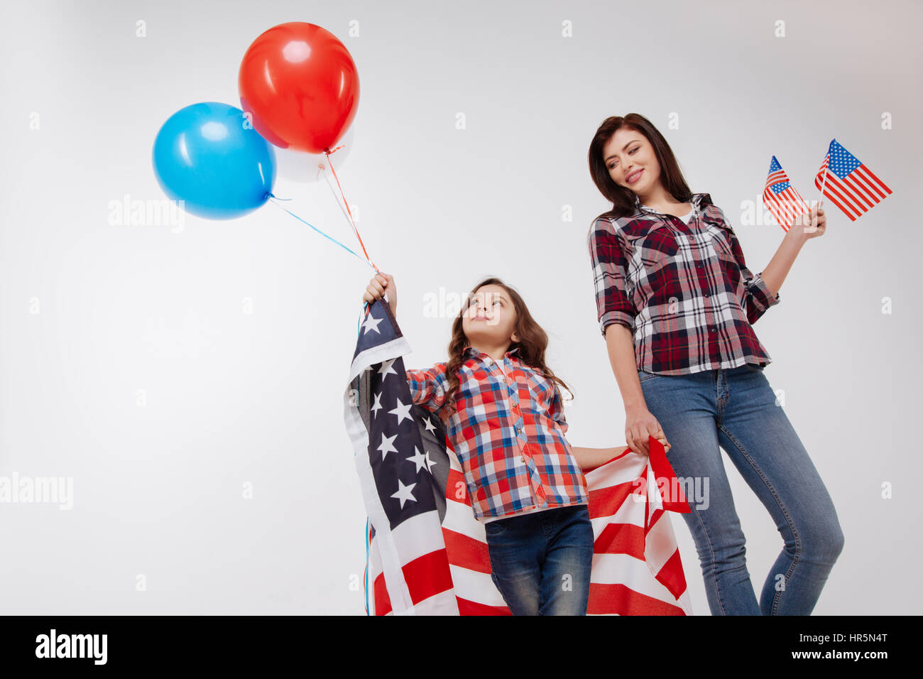 Happy motherhood. Lively amused delighted mother smiling and ...
