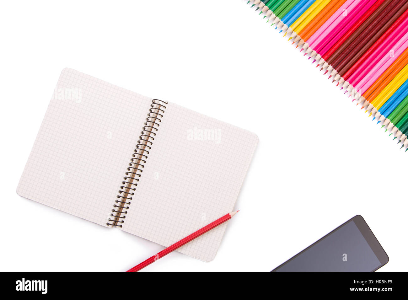 Creative workspace desk with notebook, smartphone and pencils isolated ...