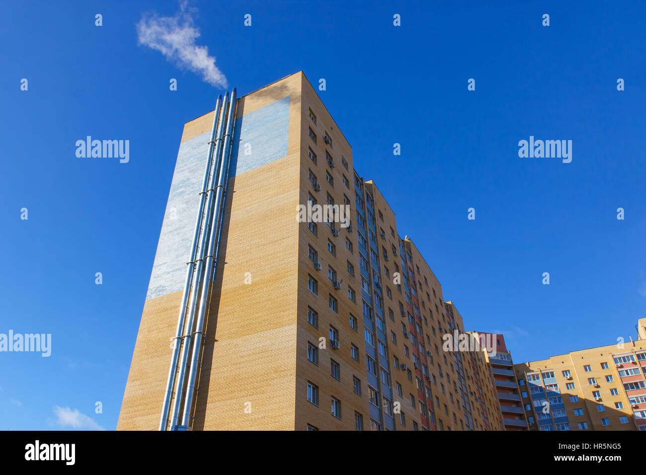 Residential building with pipes. Great against the blue sky Stock Photo ...