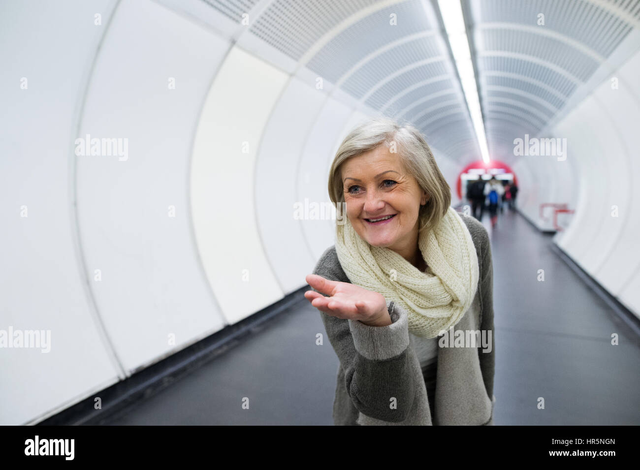 Beautiful senior woman in hallway of subway in Vienna saying goodbye ...