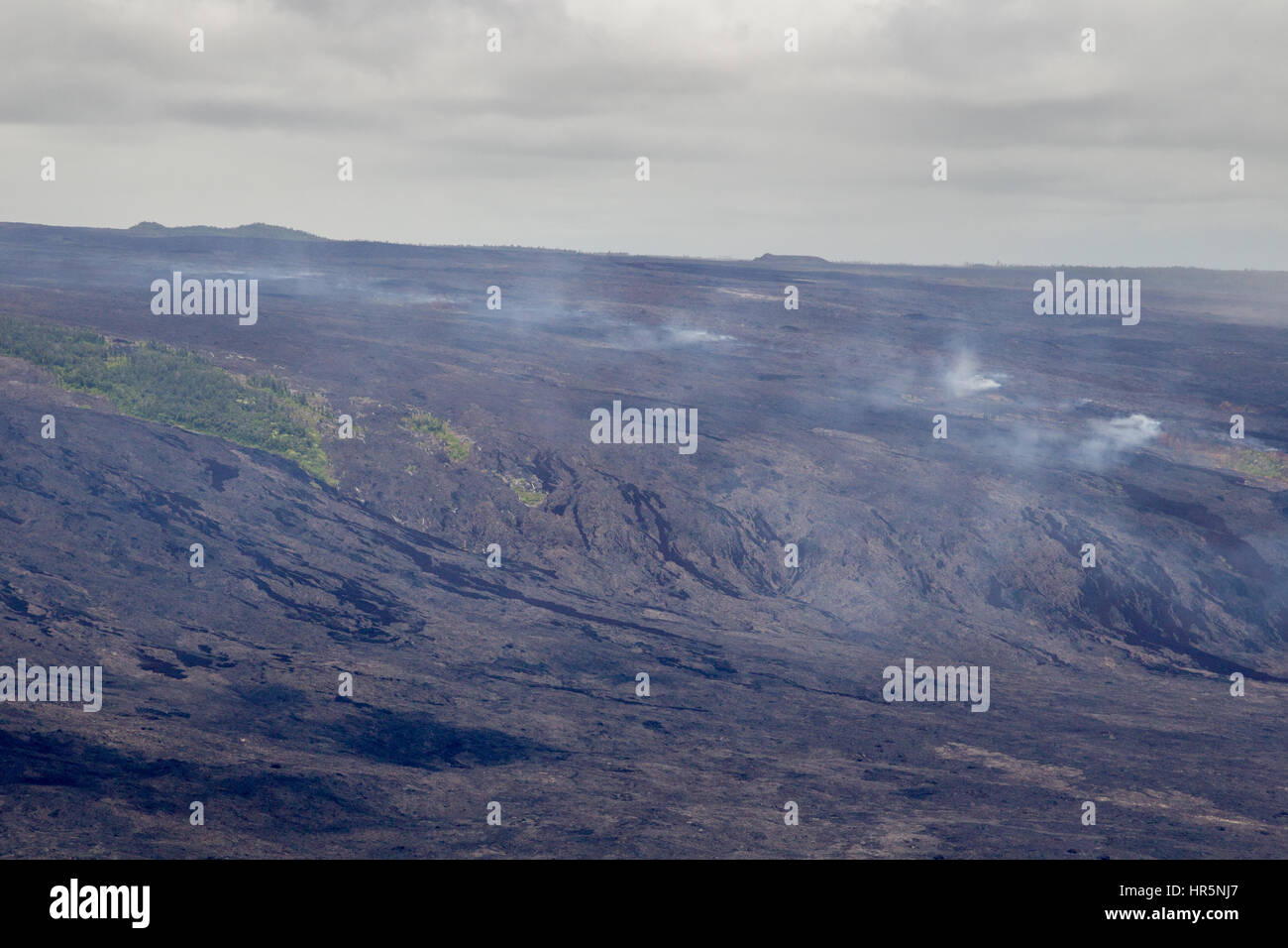 Aerial shot of volcanic fumes rising from the slopes of the active ...