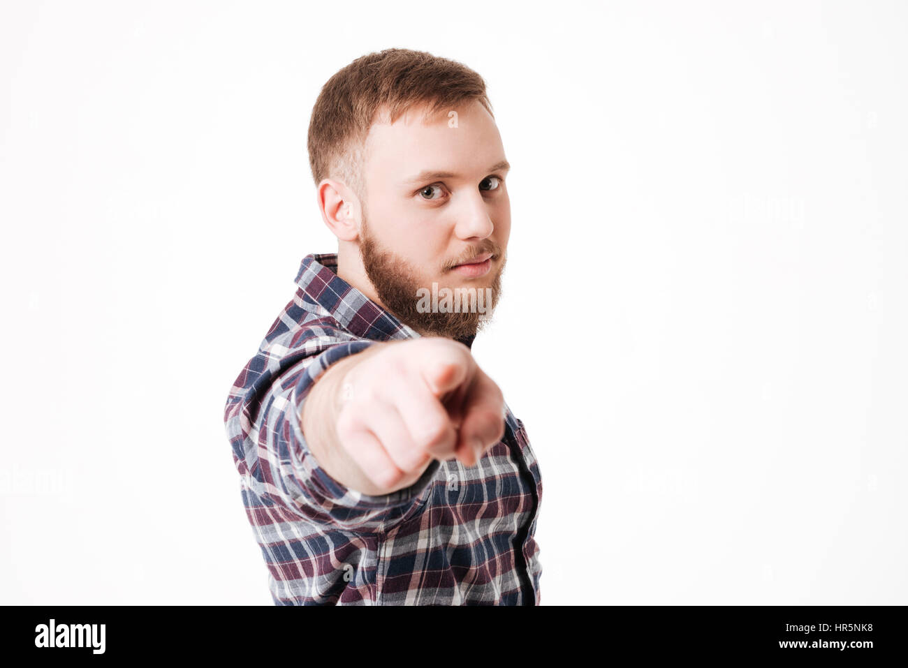 Serious Man in shirt pointing at camera. Isolated white background ...