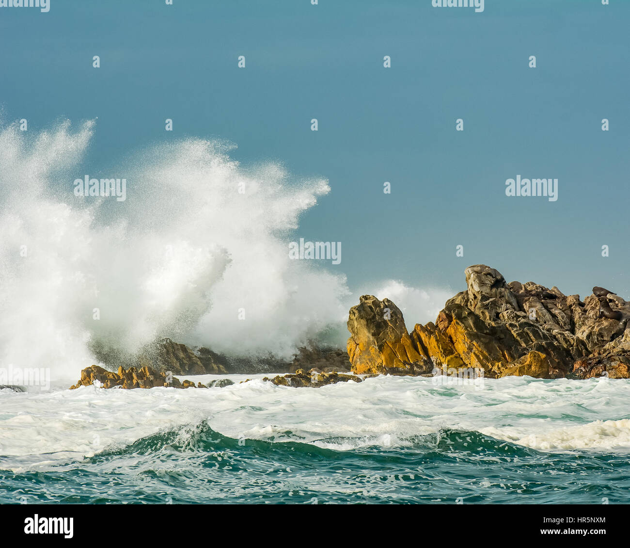 coastal rocks and splashing waves at Camps Bay in Cape Town, South ...