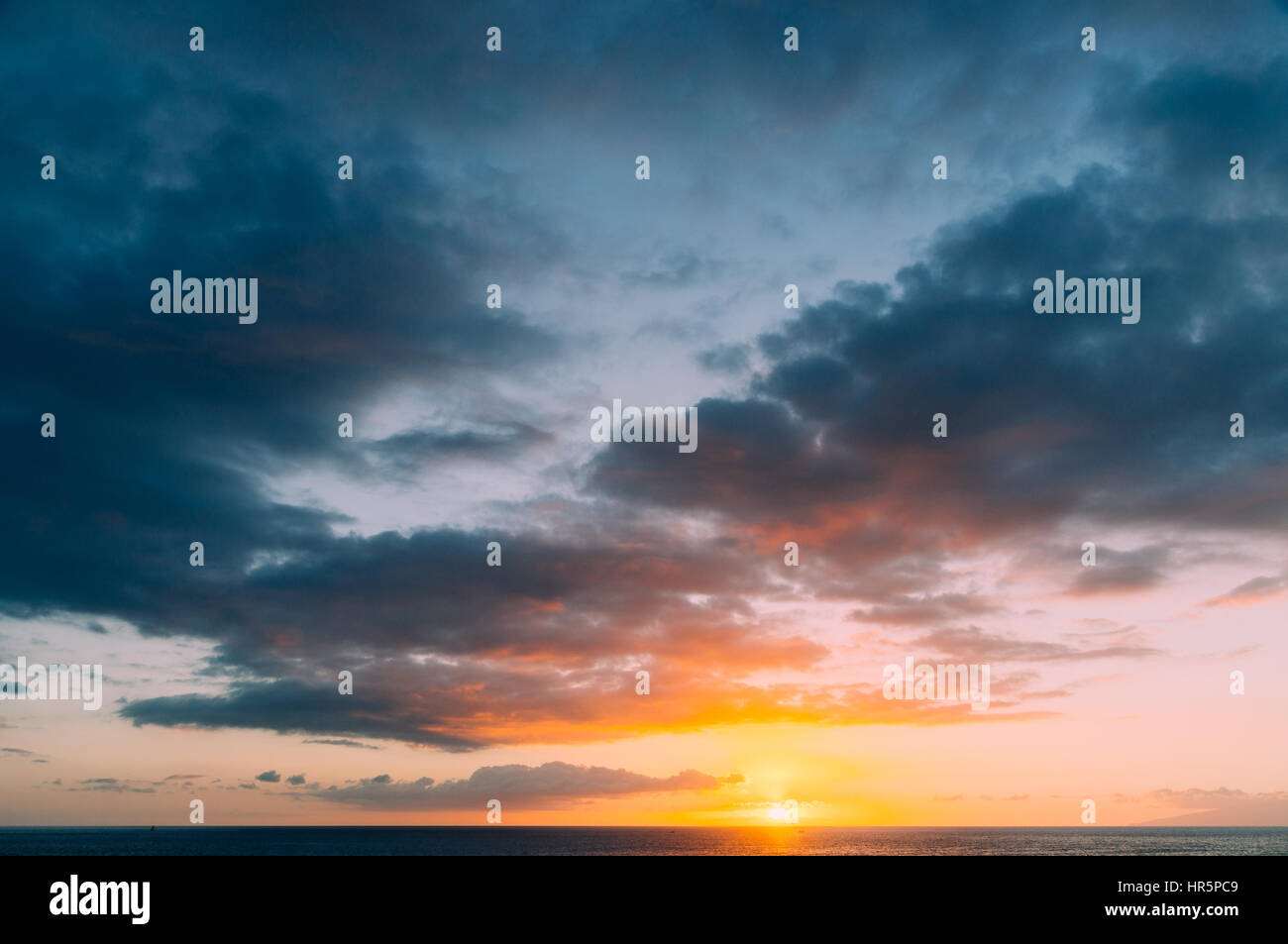 Orange and yellow clouds dark ocean hi-res stock photography and images ...