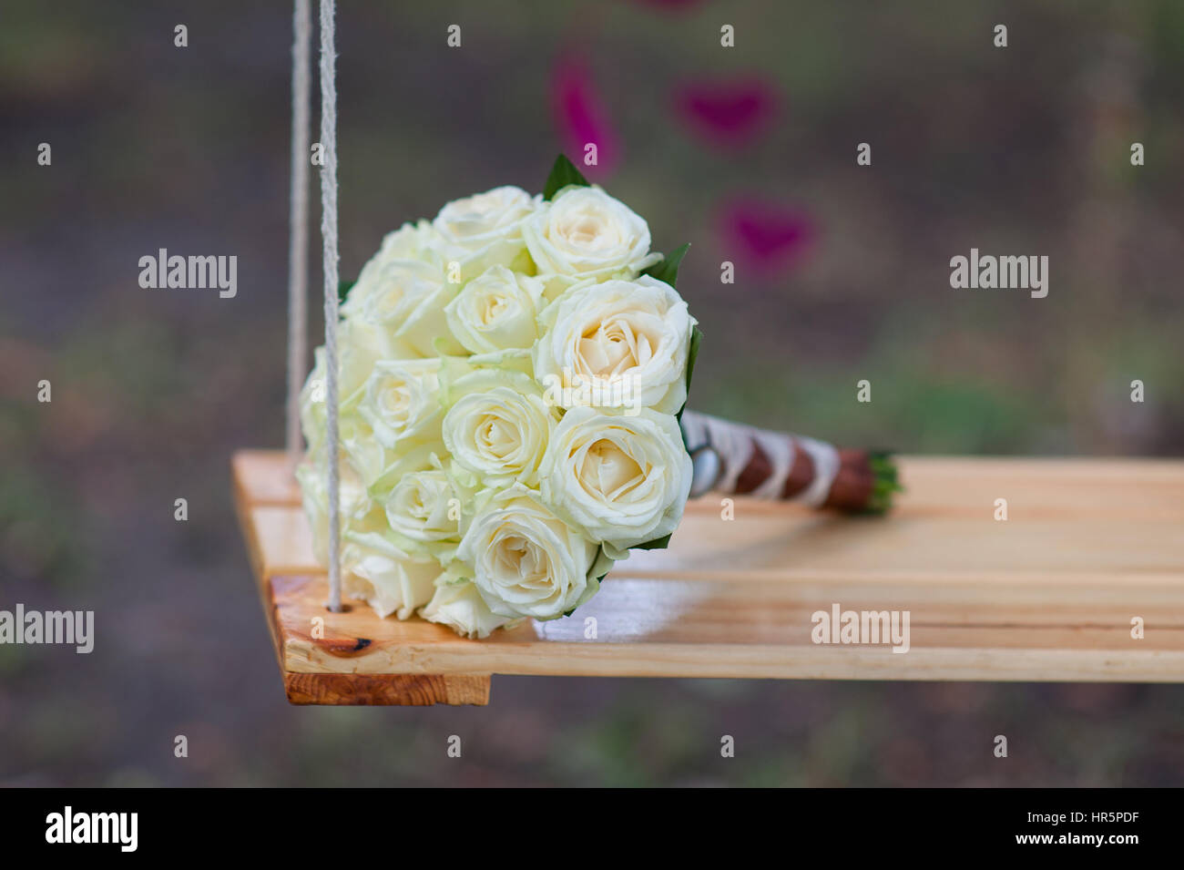 bridal bouquet of white roses lay on a swing Stock Photo - Alamy